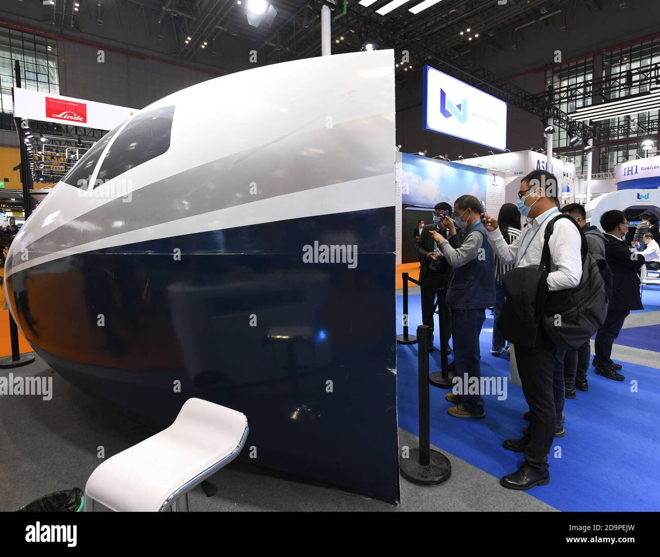 Shanghai, China. 6th Nov, 2020. People watch the flight simulator at ...