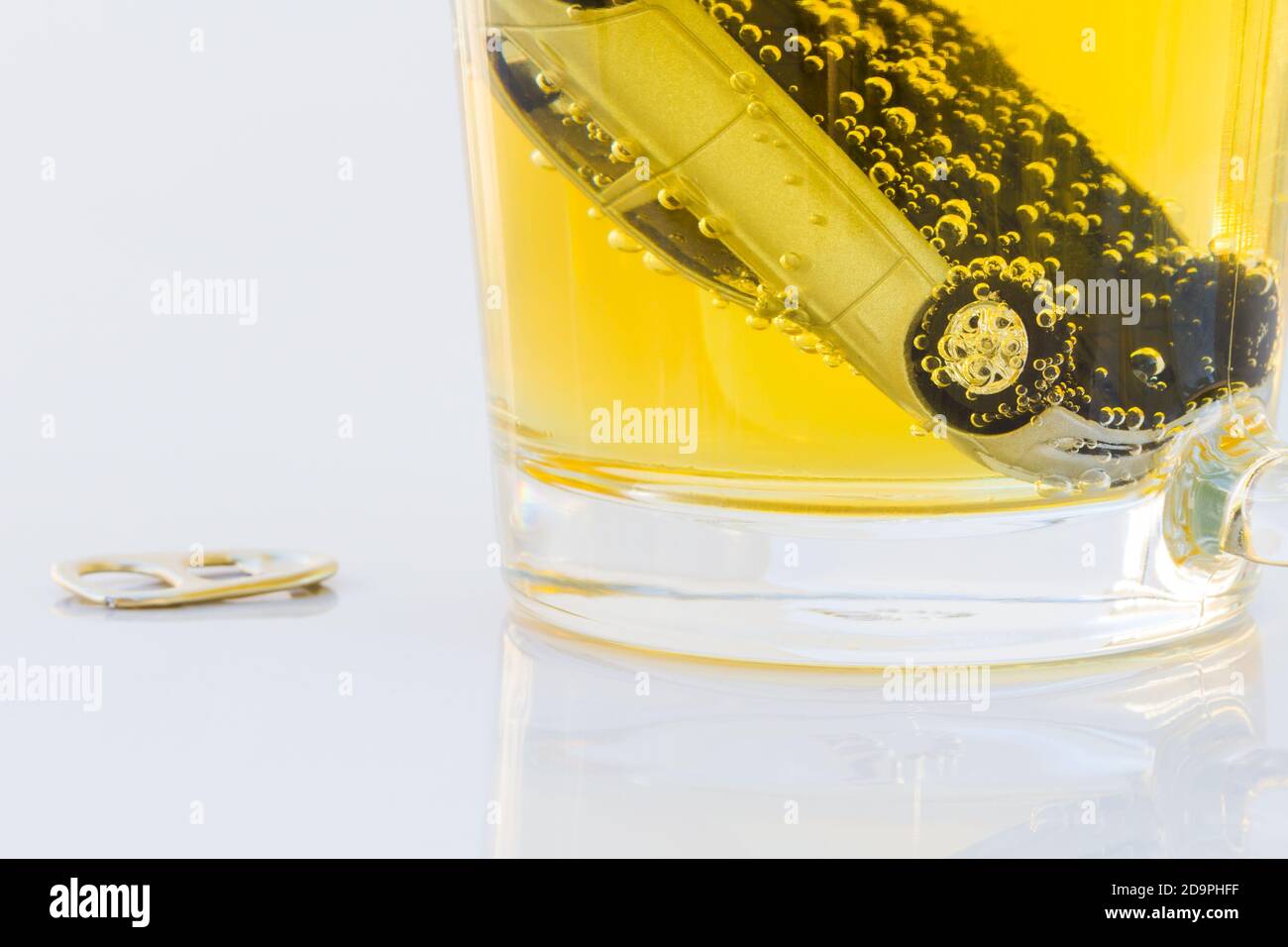 horizontal photo of toy car in a glass of beer isolated on white ...