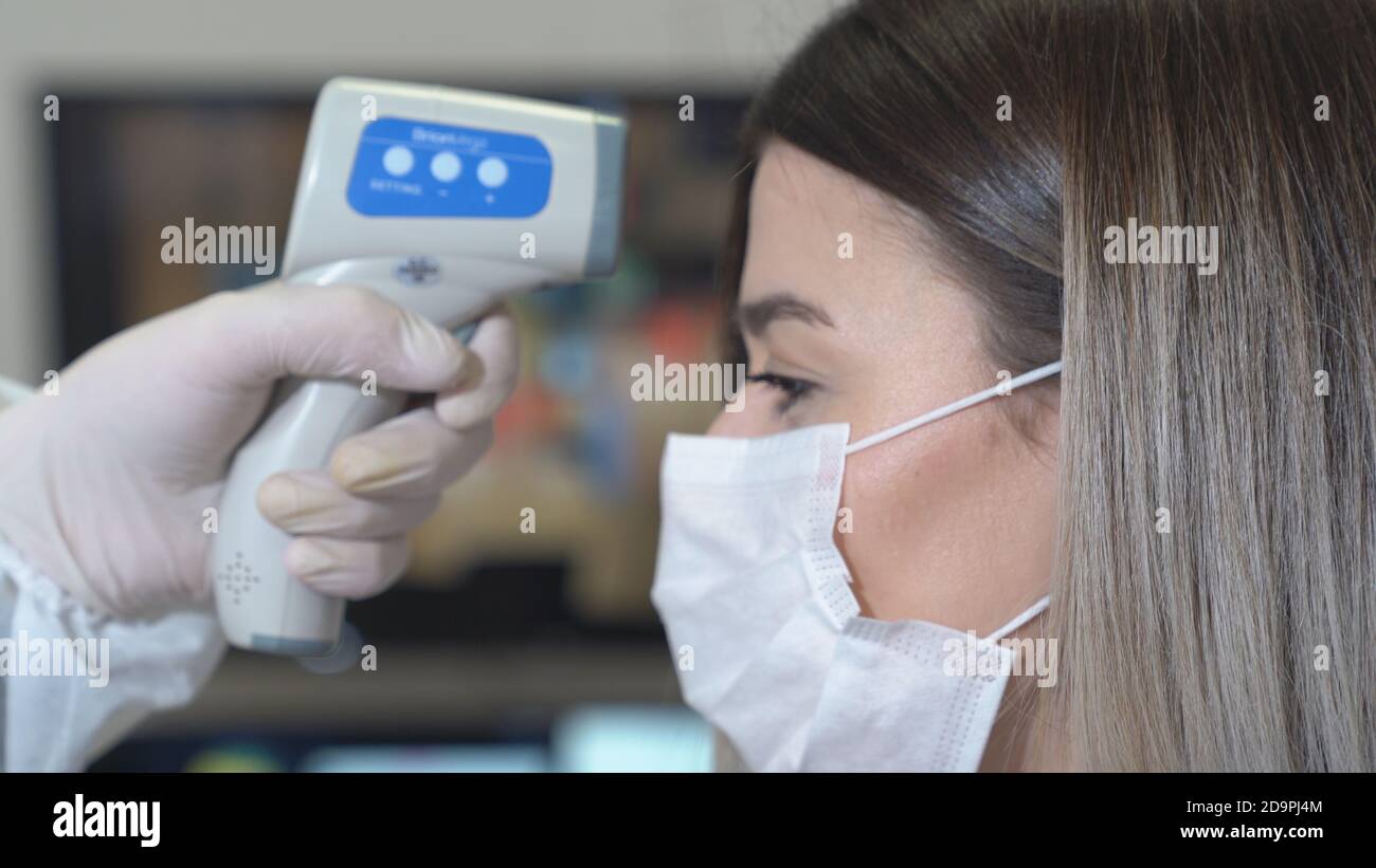 Taking woman 's temperature with thermometer to find infected by ...