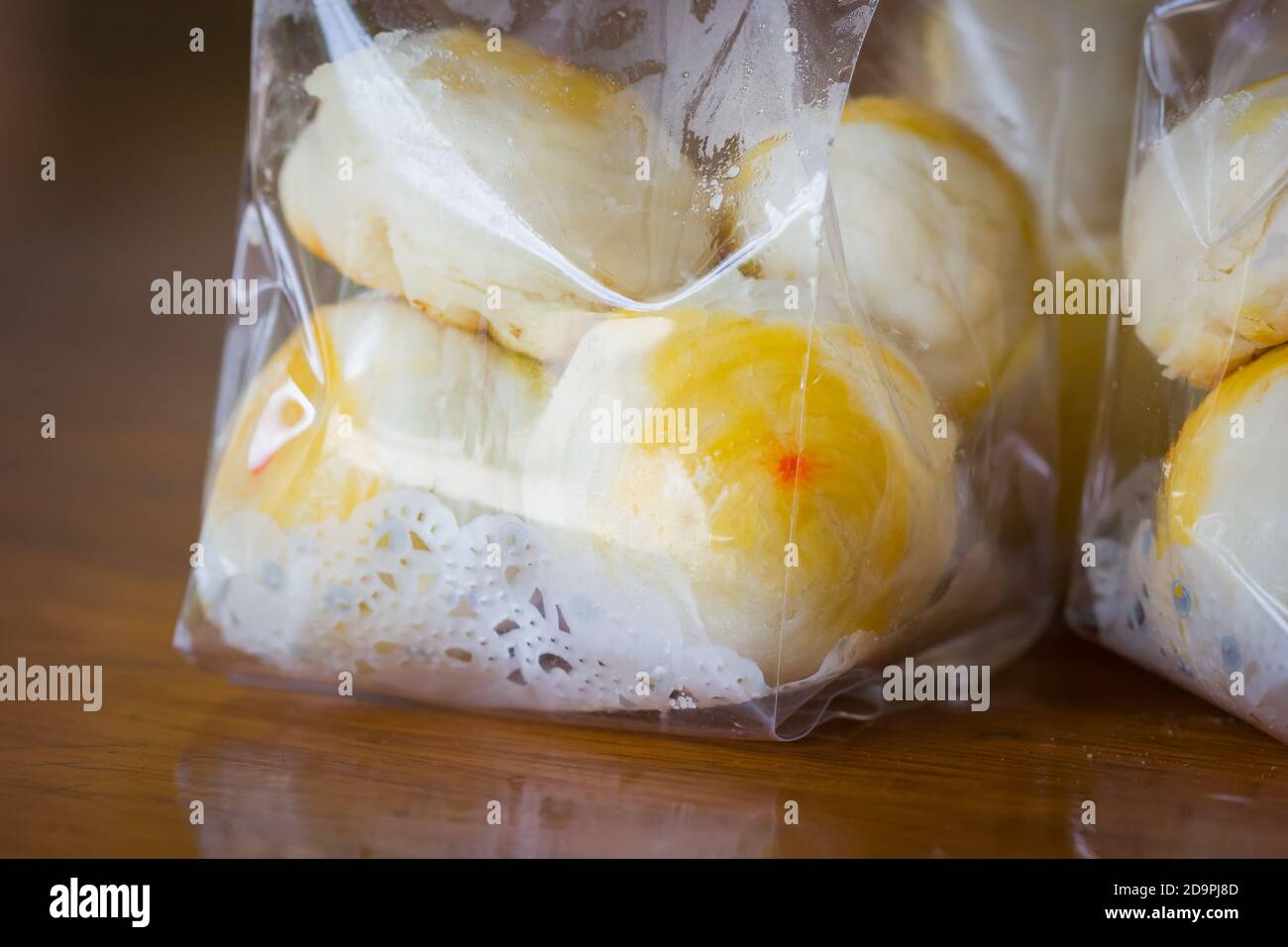 Traditional Chinese cake in plastic bag on wooden background Stock ...