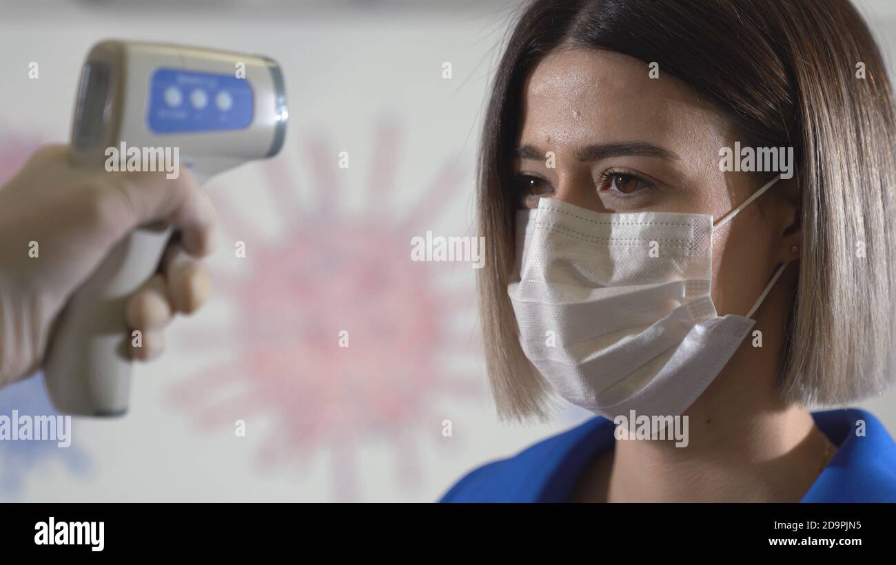 Taking woman 's temperature with thermometer to find infected by ...