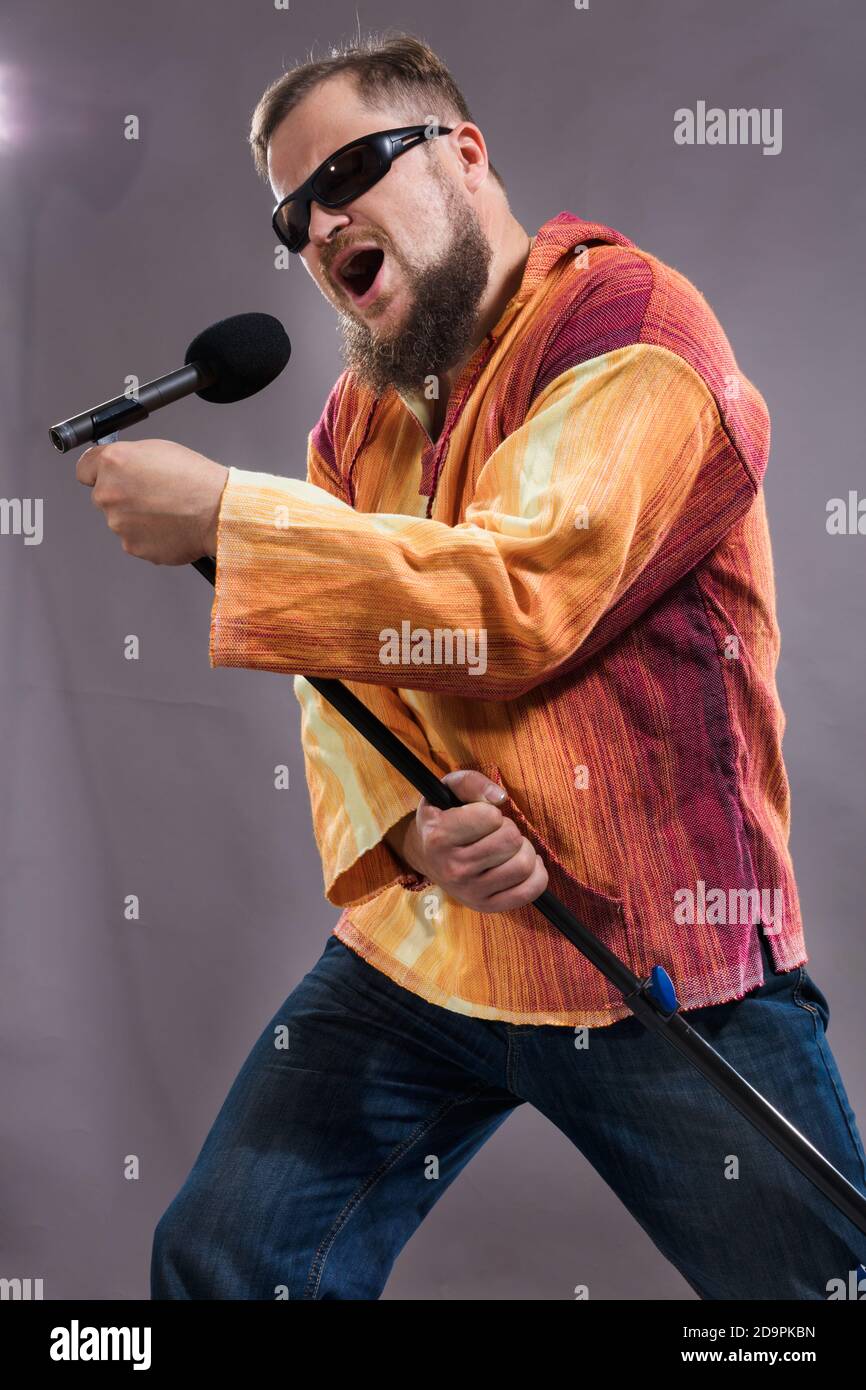 Bearded emotional rock singer with micriphone studio portrait Stock ...
