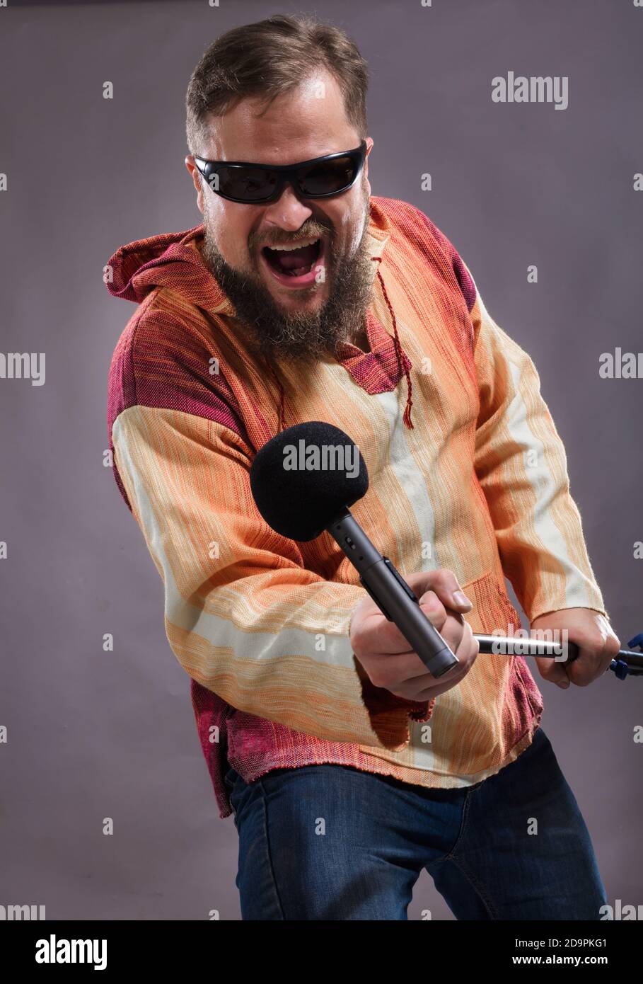 Bearded emotional rock singer with micriphone studio portrait Stock ...