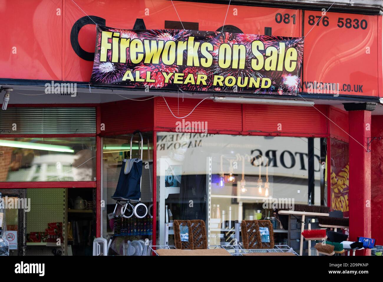 A temporary banner over a shop sign advertising year-round fireworks ...