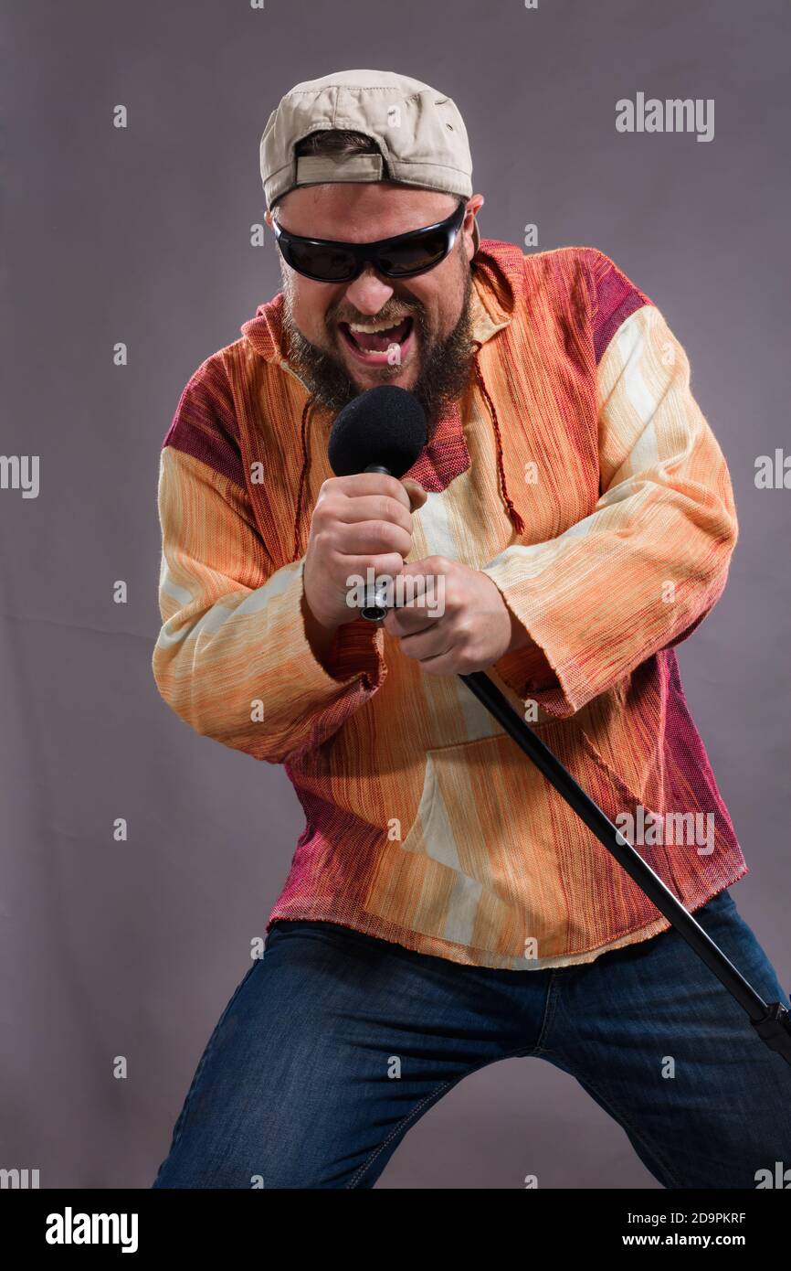 Bearded emotional rock singer with micriphone studio portrait Stock ...