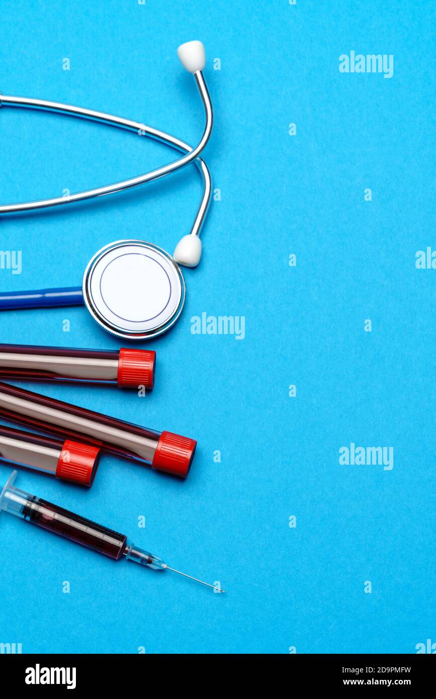 Top view of Medical equipment on blue background - stethoscope, syringe ...