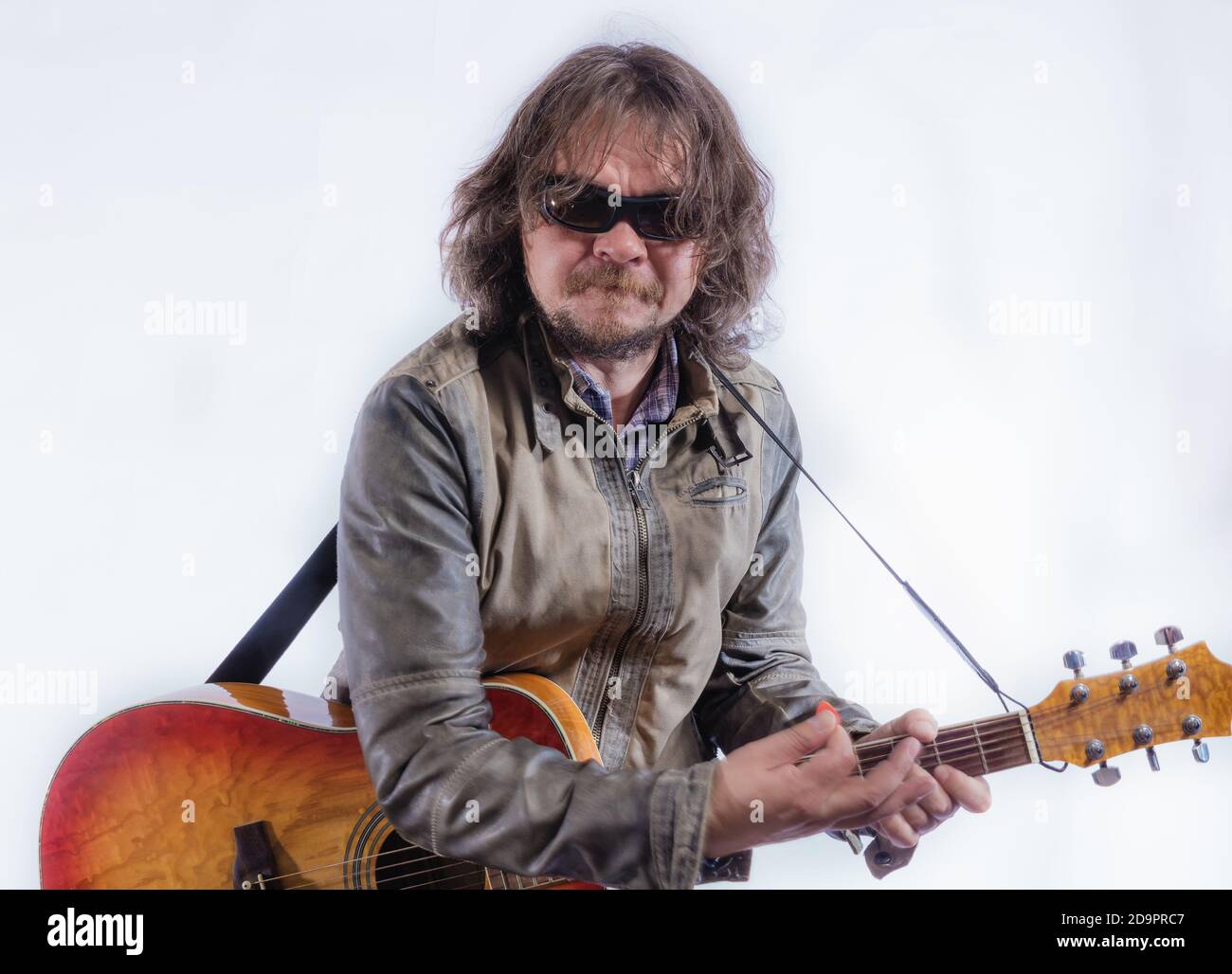 Mature musician plays acoustic guitar studio portrait Stock Photo - Alamy