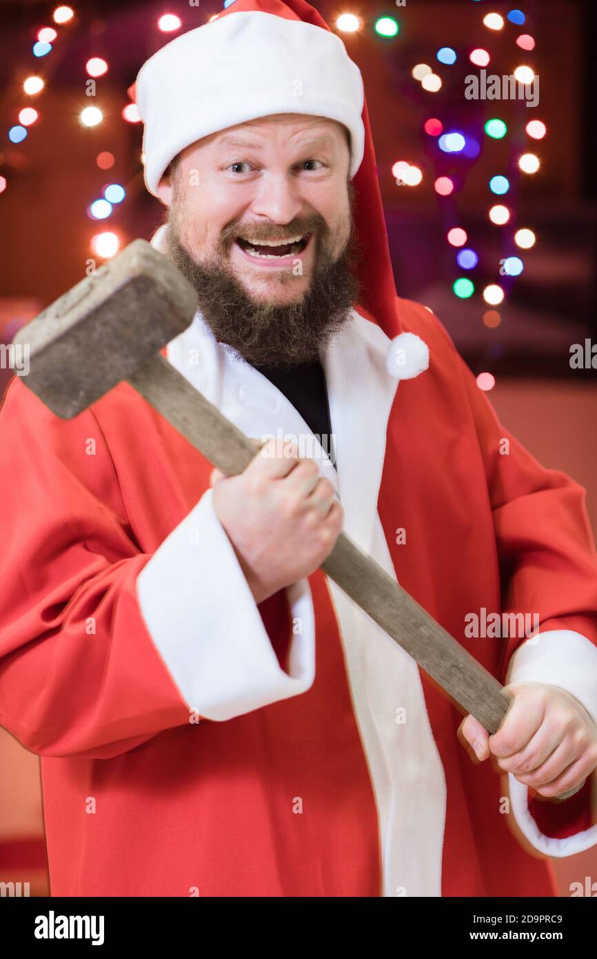 Santa Claus with hammer humor studio portrait with lights on background ...