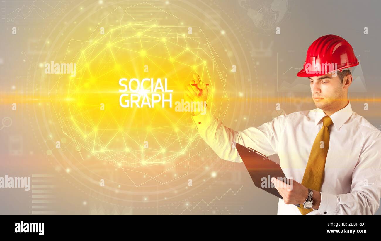 Handsome businessman with helmet drawing SOCIAL GRAPH inscription ...