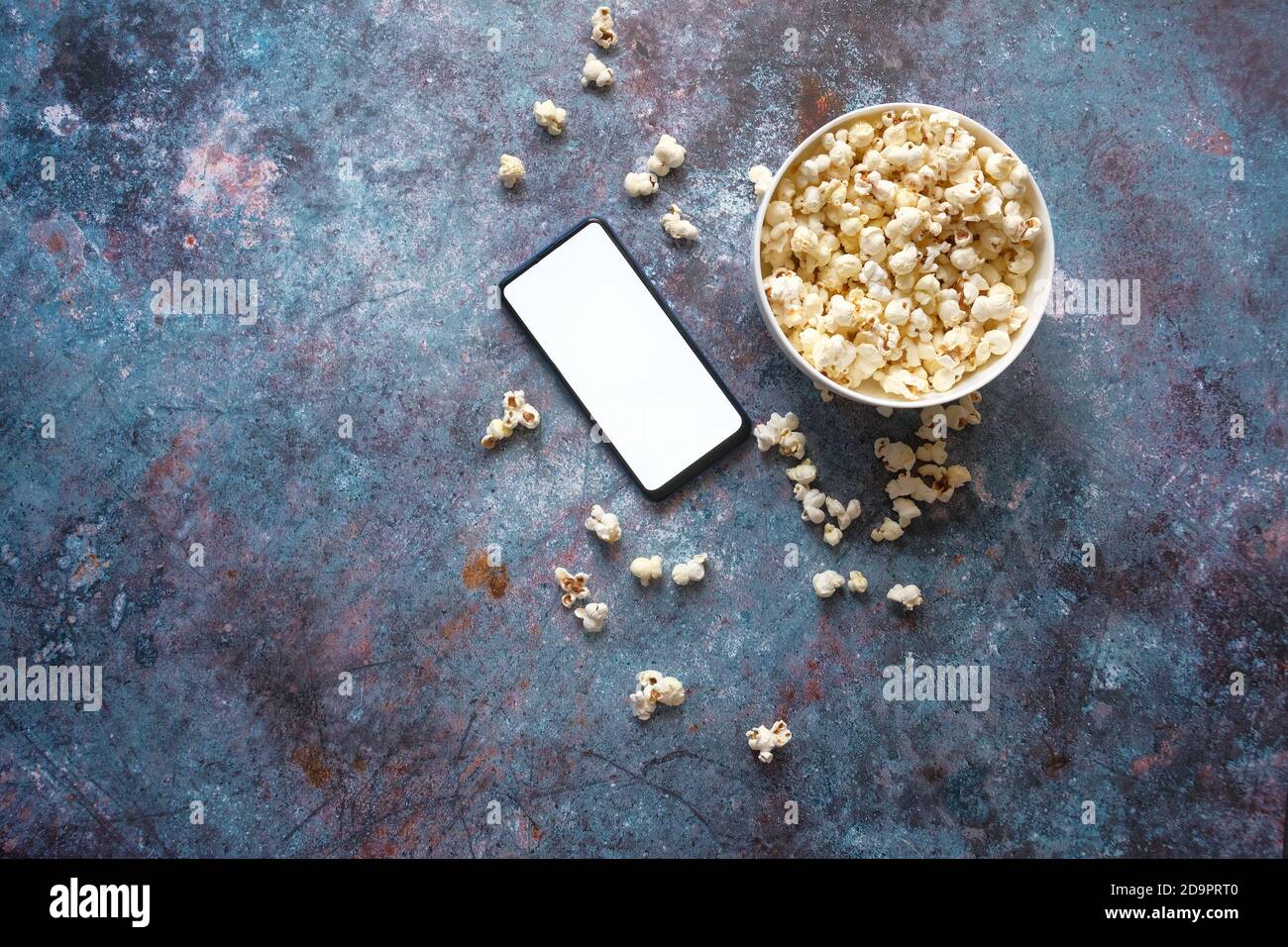 top view of smart phone and popcorn on table Stock Photo - Alamy