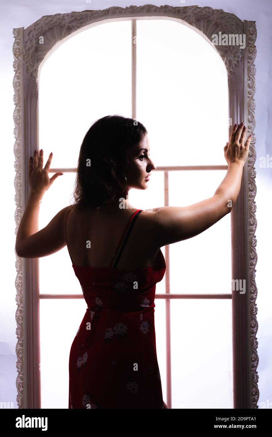 Beautiful young woman on white window background studio portrait Stock ...