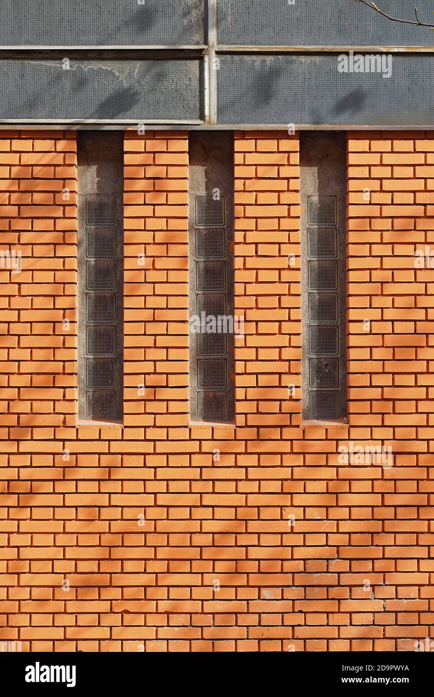 Three windows at new orange brick wall building Stock Photo - Alamy