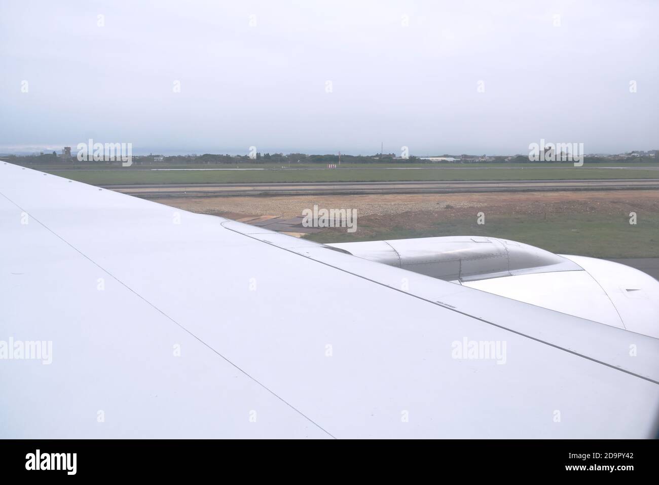 plane wing while take off from runway through window frame Stock Photo ...