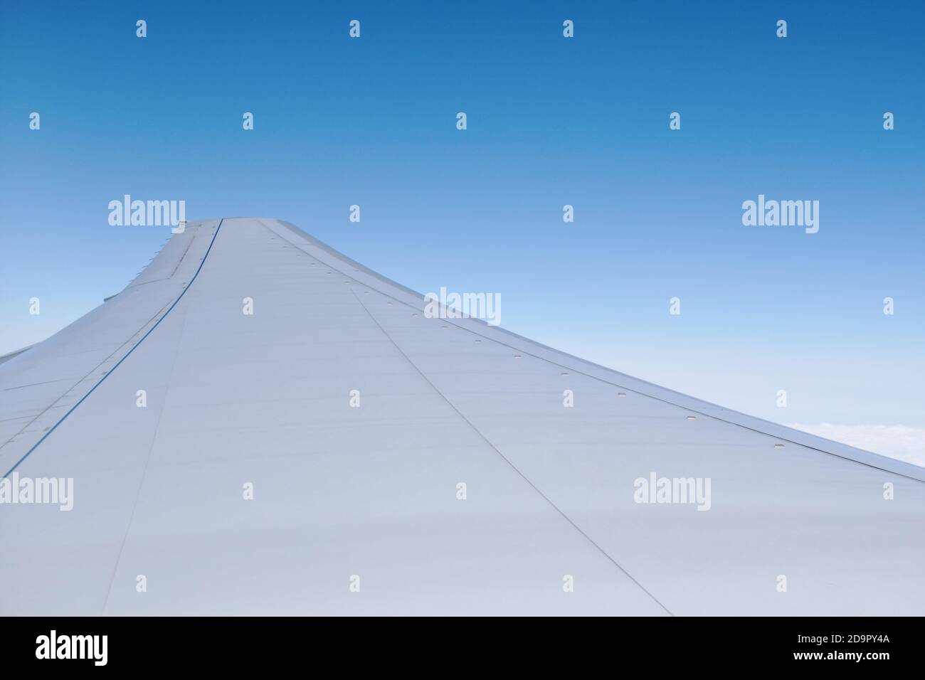 plane wing and cloud floating on sky through window frame Stock Photo ...
