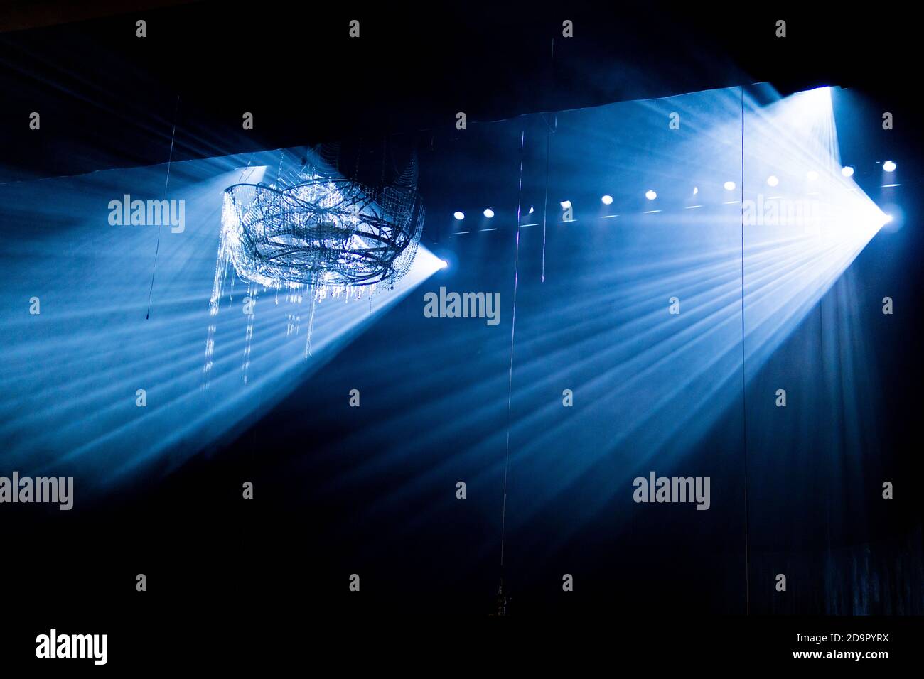 empty stage of the theater, lit by spotlights and smoke before the ...