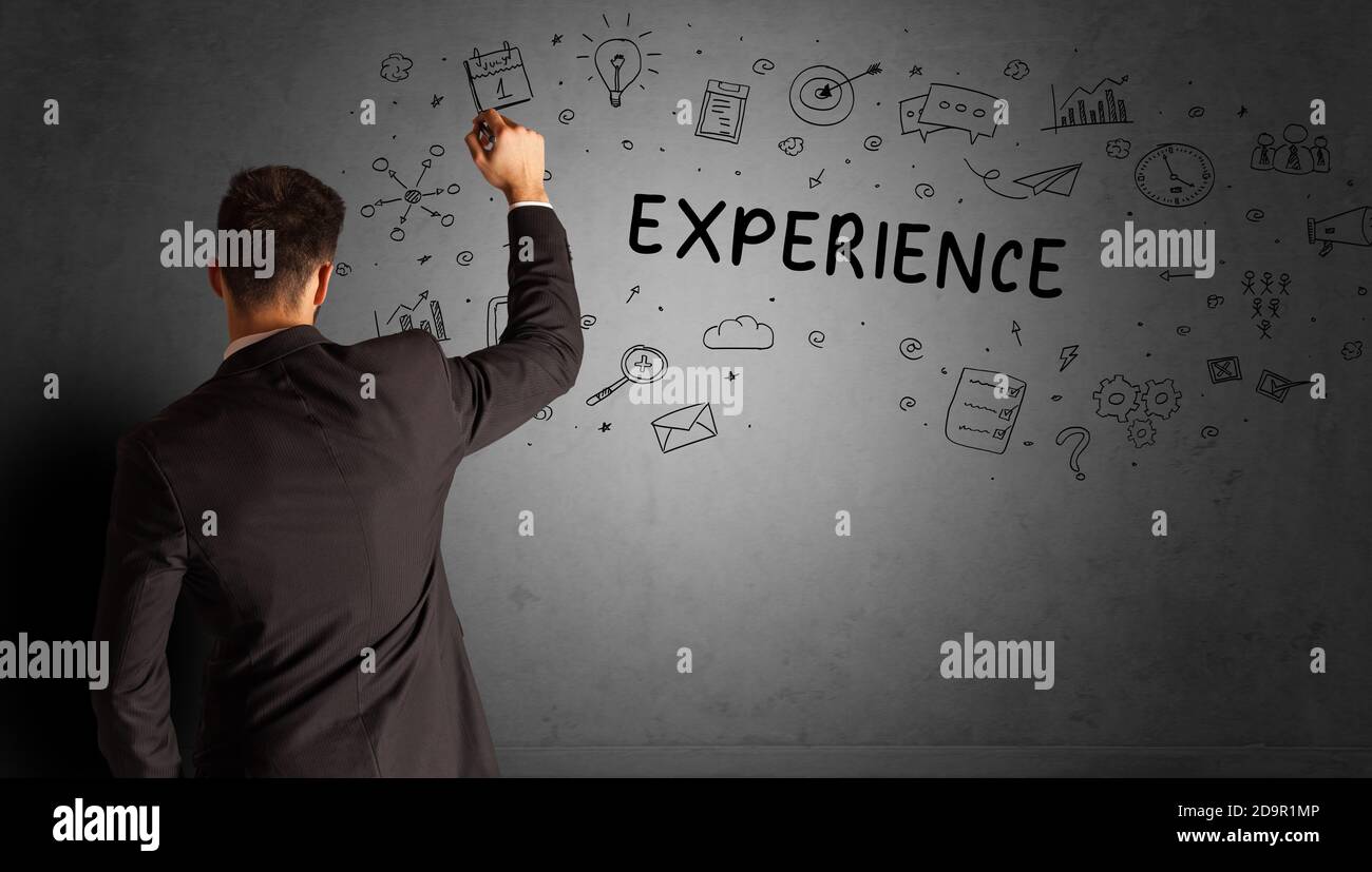 businessman drawing a creative idea sketch with EXPERIENCE inscription ...
