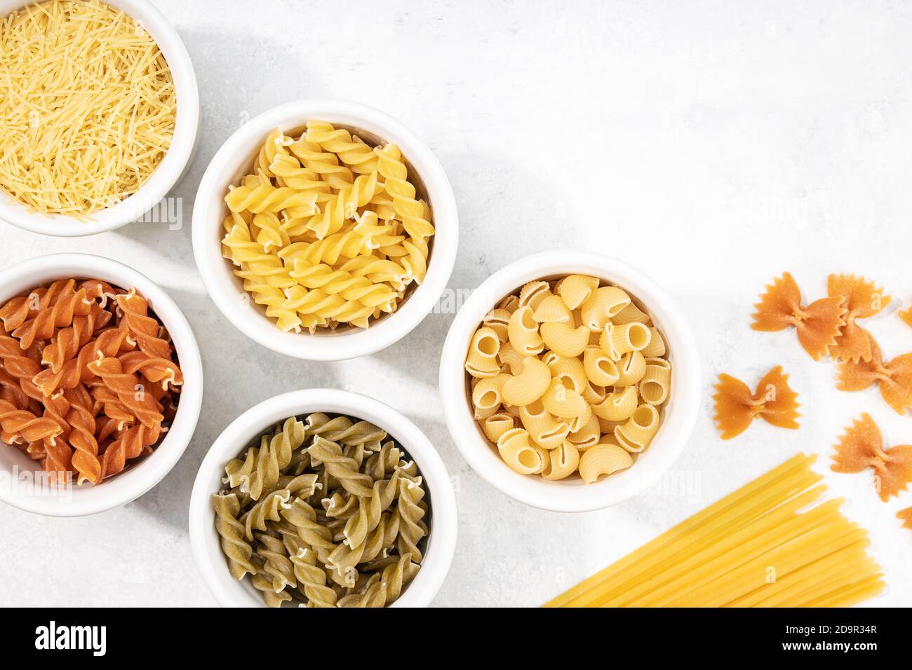 Top view of bowls with assorted uncooked pasta. Mediterranean food ...