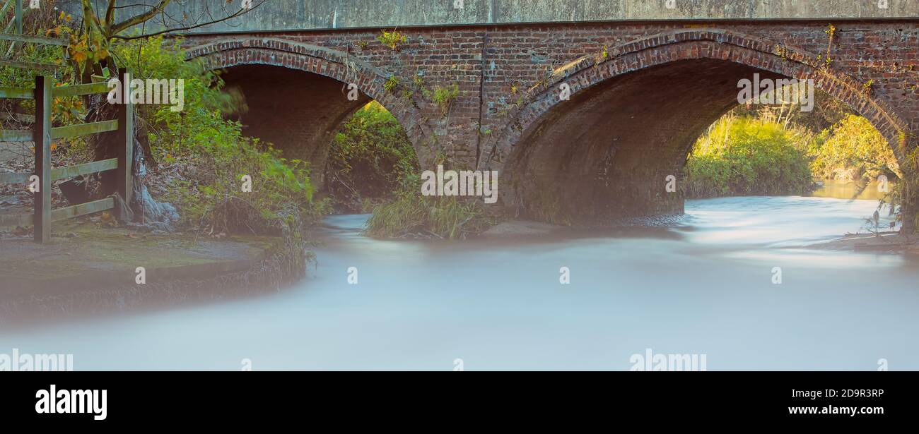 Old river bridge in Autumn with a smoky river running through Stock ...
