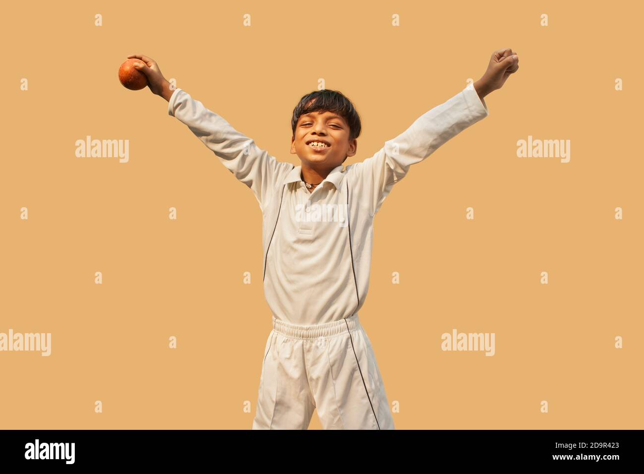 Boy catching cricket ball and celebration Stock Photo - Alamy