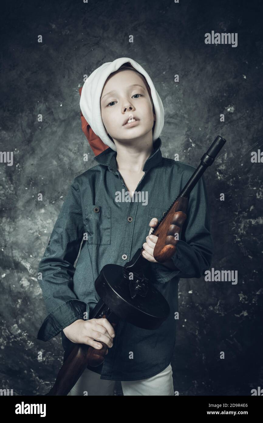 Little Santa in red cap with a gun studio portrait Stock Photo - Alamy