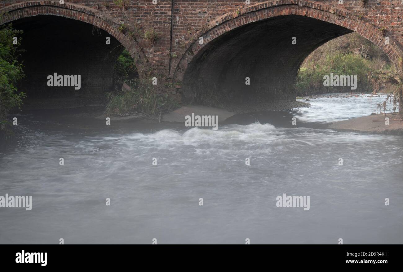 Old river bridge in Autumn with a smoky river running through Stock ...