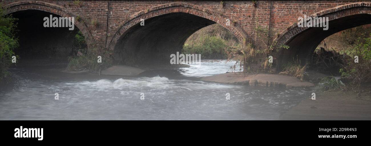 Old river bridge in Autumn with a smoky river running through Stock Photo - Alamy