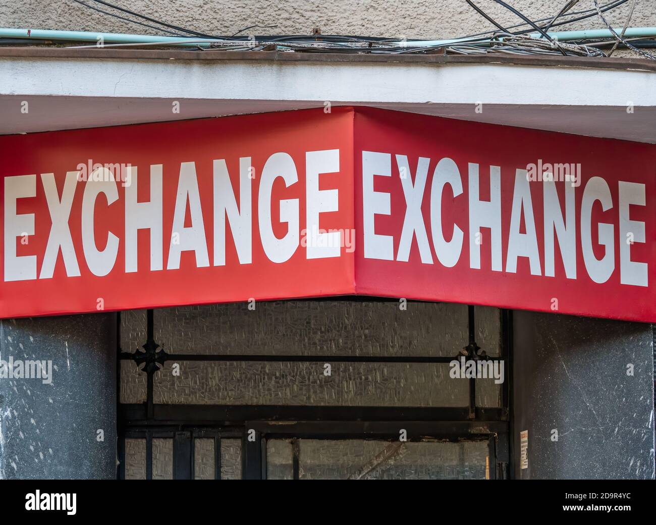 Exchange red sign above the entrance of a money exchange shop Stock ...