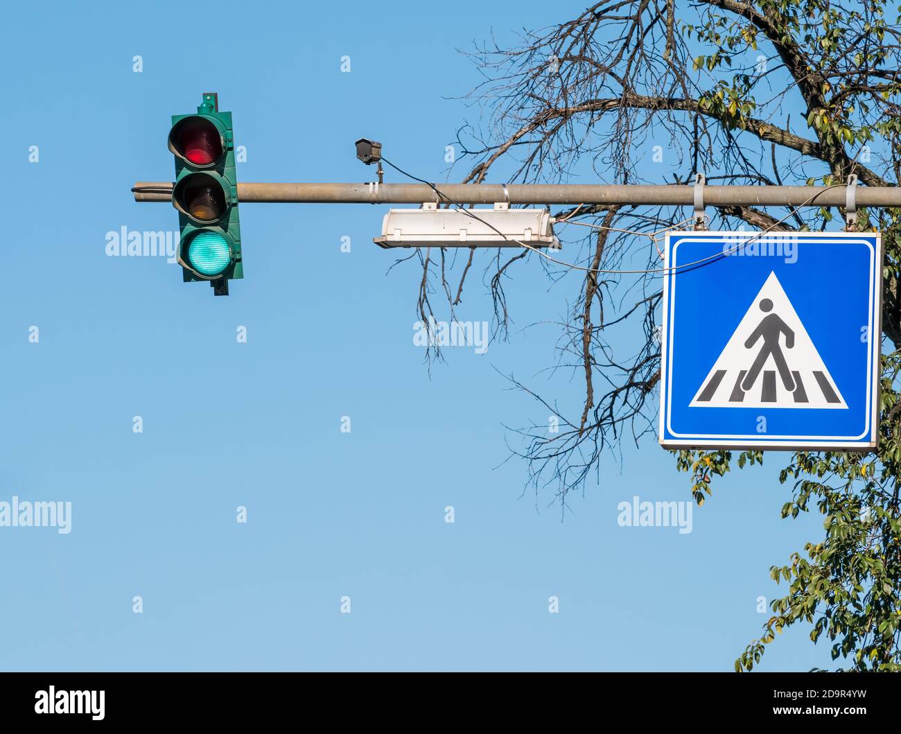 Zebra crossing sign and traffic light showing green light in Bucharest ...