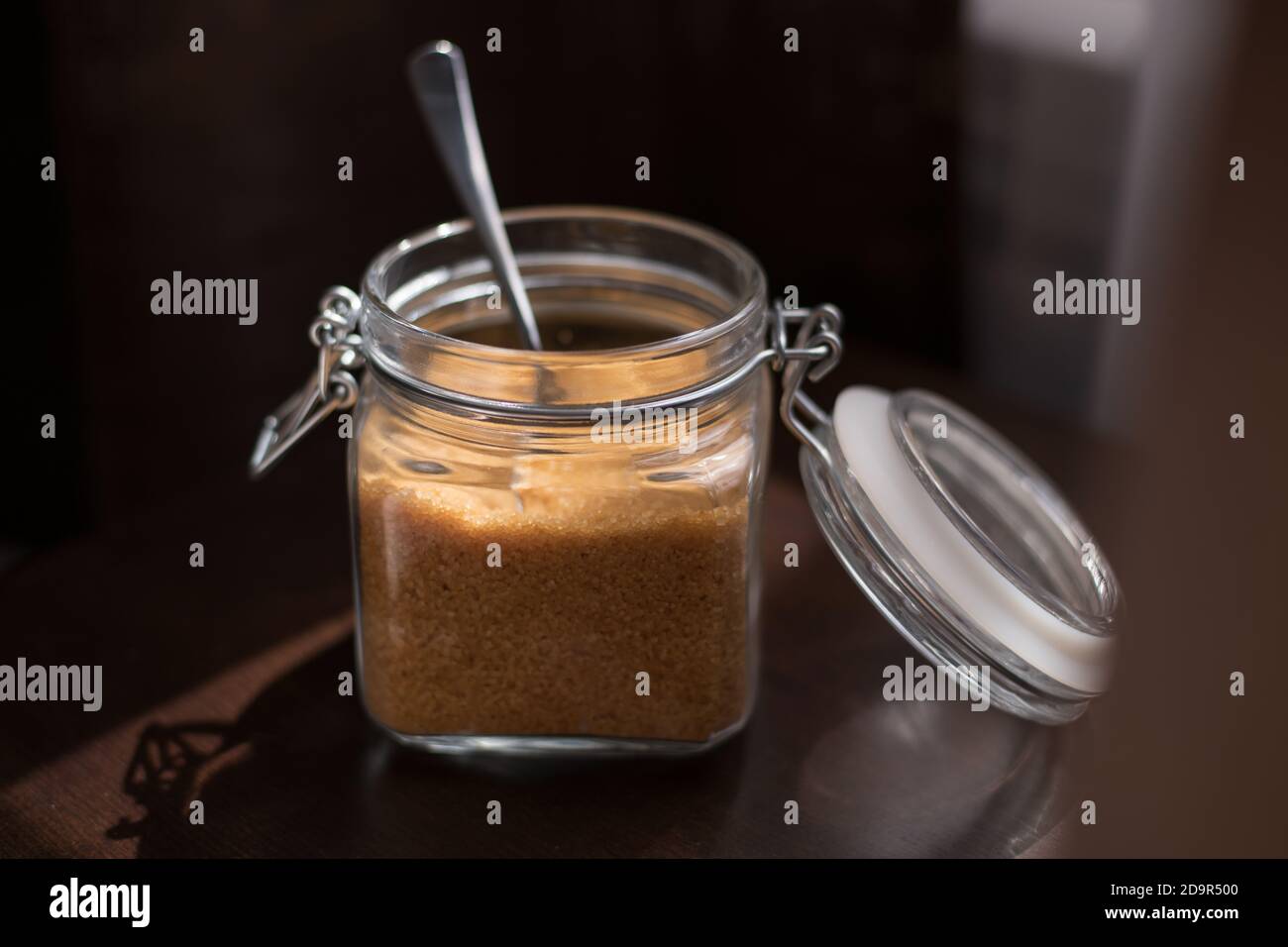 Transparent glass jar with brown sugar cane on a black background Stock ...