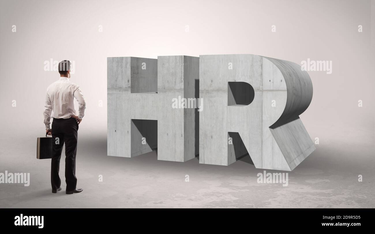 Rear view of a businessman standing in front of HR abbreviation, modern ...