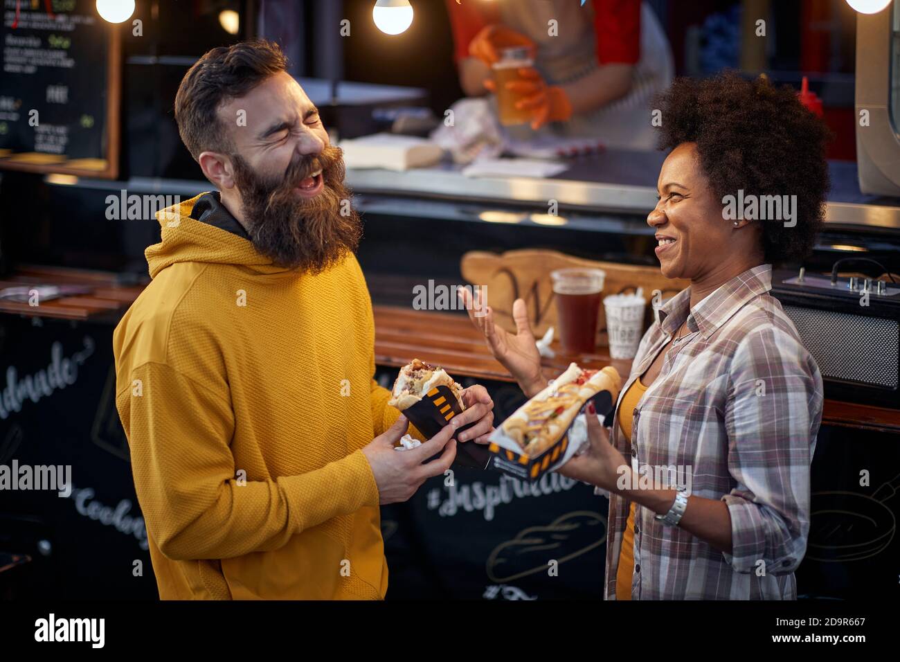 multiethnic couple laughing out loud, having a good time, talking ...