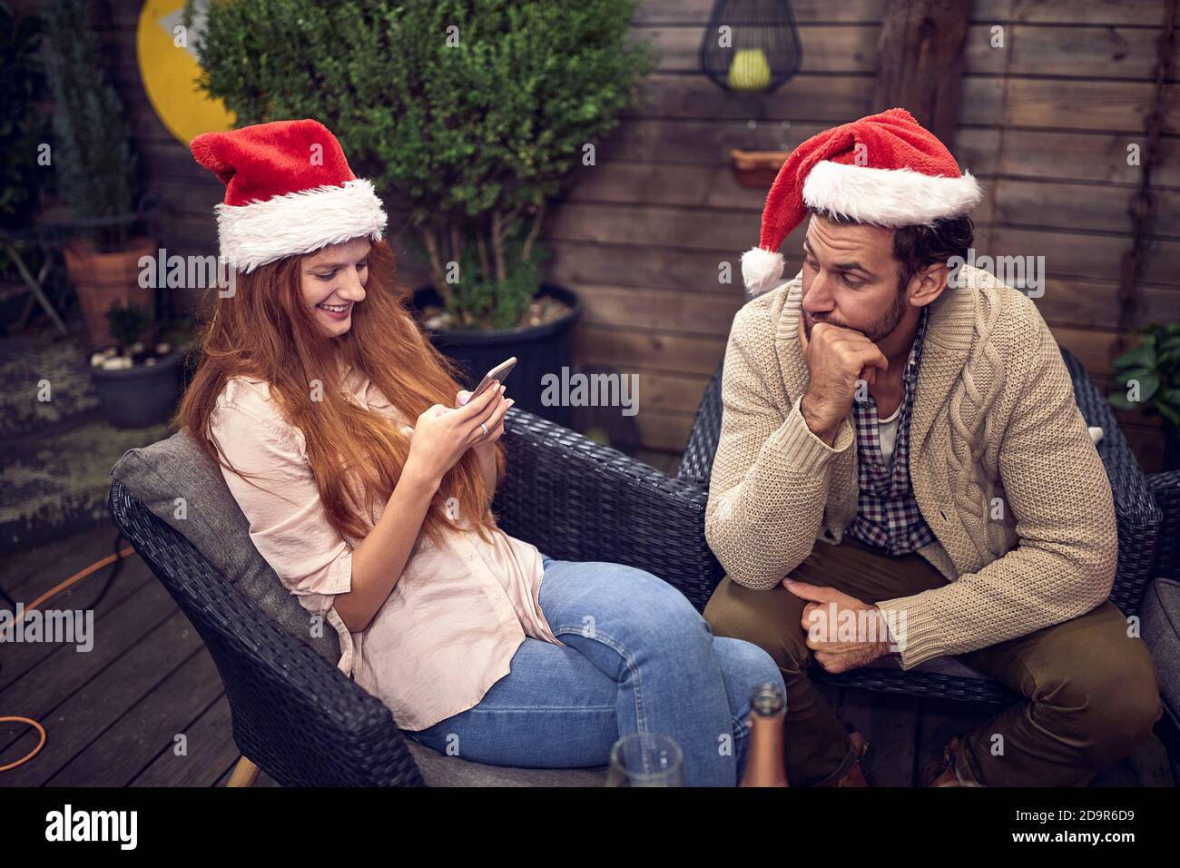 bored caucasian guy looking at female texting on her cell phone on new ...