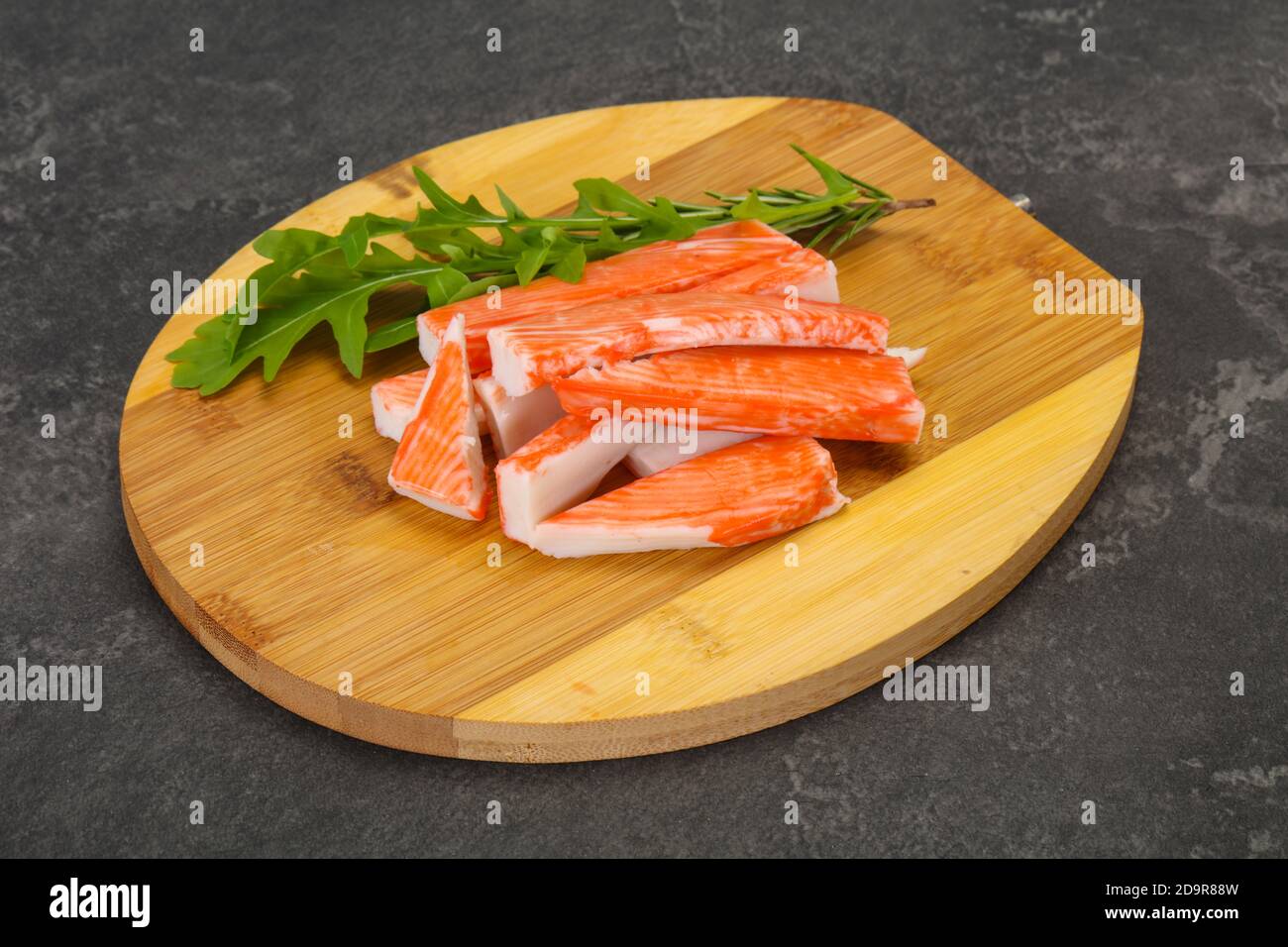 Crab stick surimi over wooden board Stock Photo - Alamy