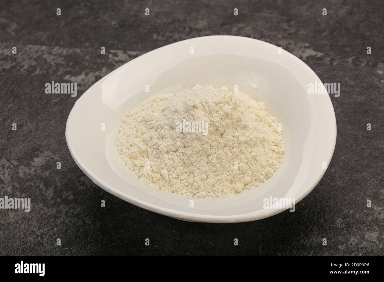 Wheat flour heap in the bowl for cooking Stock Photo - Alamy