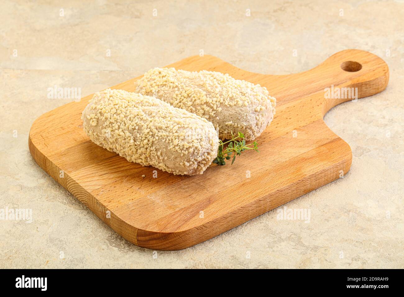 Raw breaded chicken cutlet for roast Stock Photo - Alamy