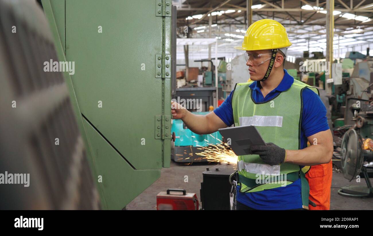 Smart factory worker using machine in factory workshop . Industry and ...