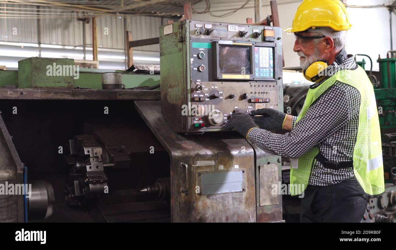 Smart factory worker using machine in factory workshop . Industry and ...