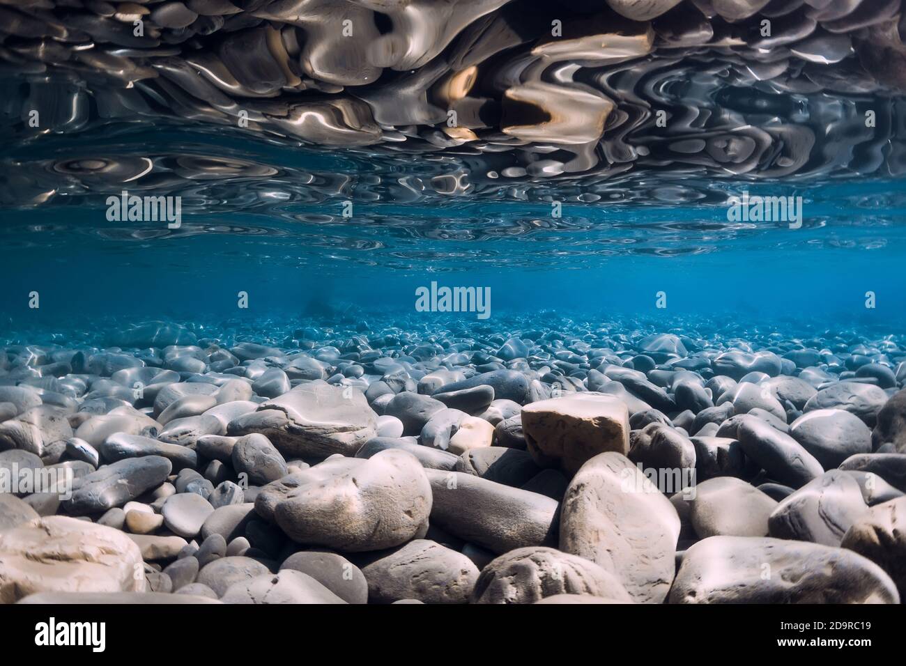 Underwater sea with stones, reflection and blue water Stock Photo - Alamy
