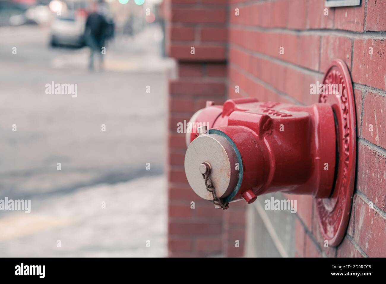 Fire department Water Hydrant on a brick wall Stock Photo - Alamy