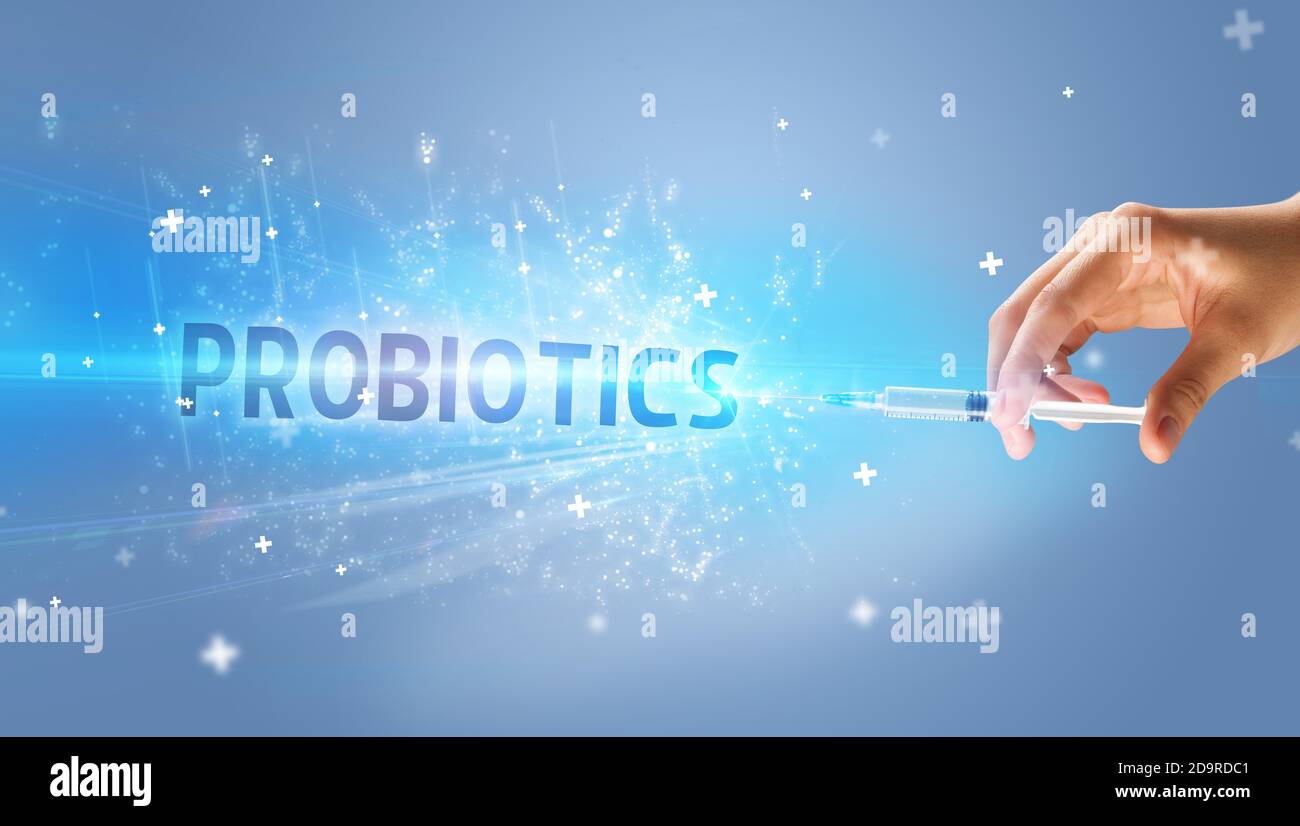 Syringe, medical injection in hand with PROBIOTICS inscription, medical ...