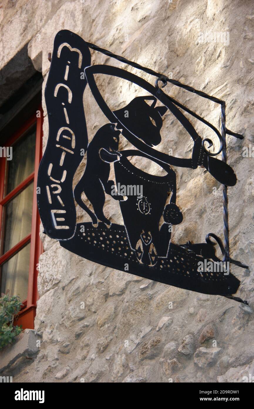 Signage intricately designed and worked in wrought iron are works of ...