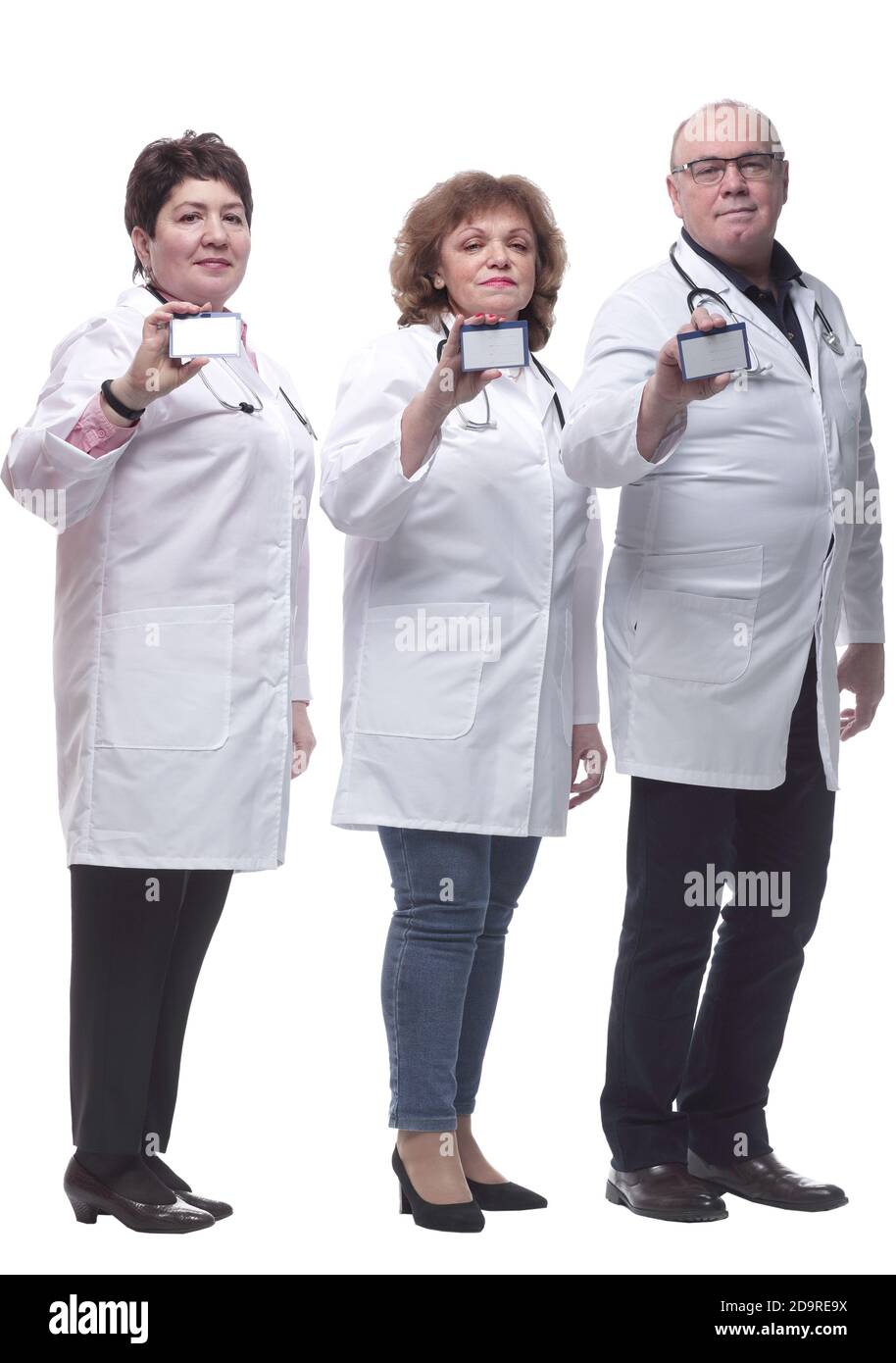 in full growth. a group of qualified doctors showing visiting cards ...