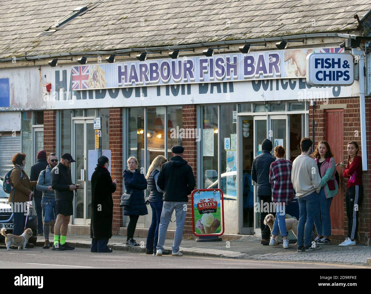 People queue outside a fish and chips shop in Folkestone, Kent, on the ...