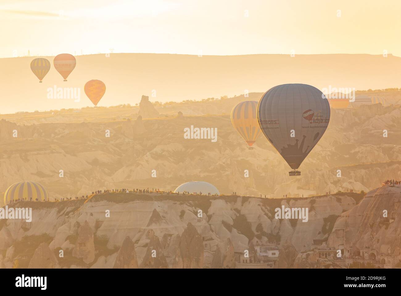 Hot Air balloons flying over Cappadocia valleys on sunrise Stock Photo ...