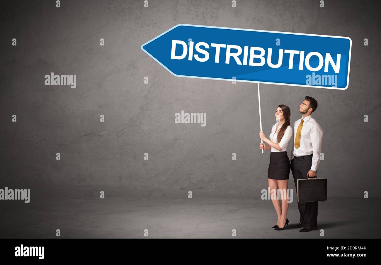 Young business person in casual holding road sign with DISTRIBUTION ...