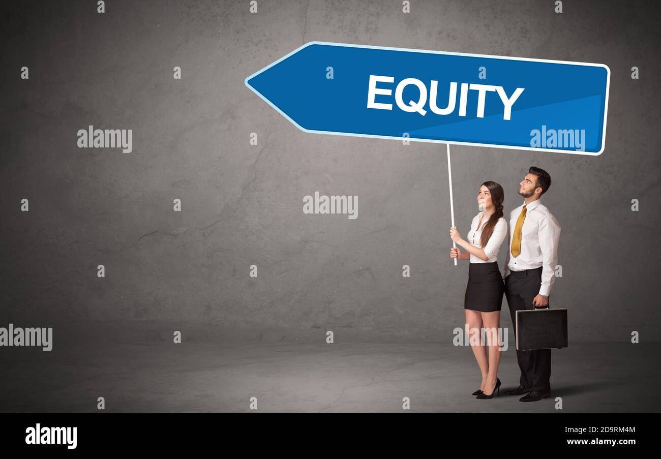 Young business person in casual holding road sign with EQUITY ...