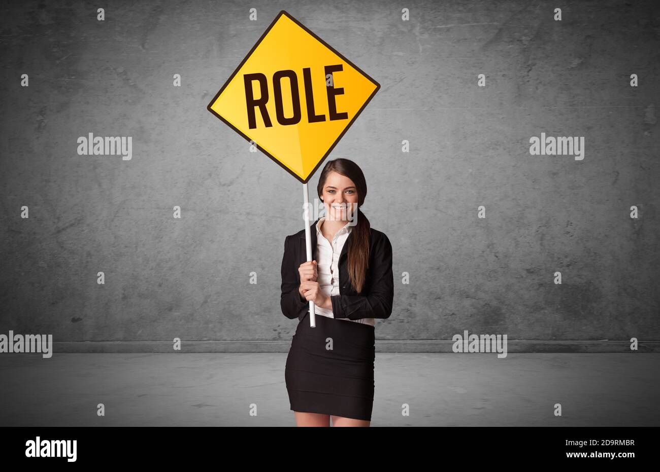 Young business person holding road sign with ROLE inscription, new ...