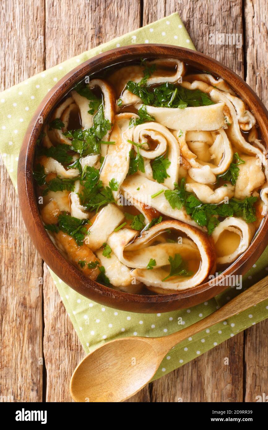 Frittatensuppe sliced pancake soup close-up in a plate on the table ...
