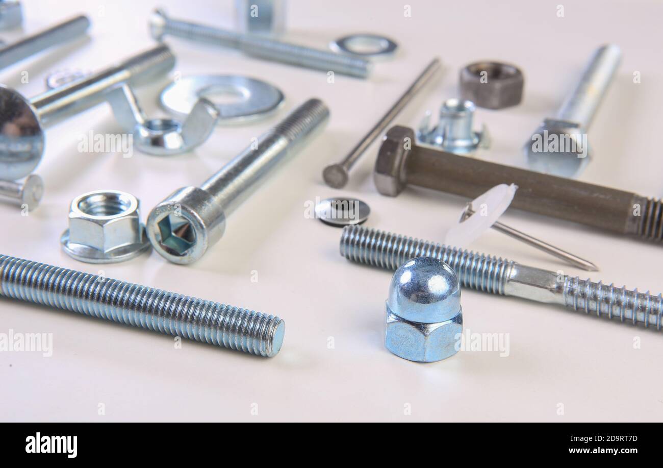 chromeplated bolts and nuts on white background Stock Photo - Alamy