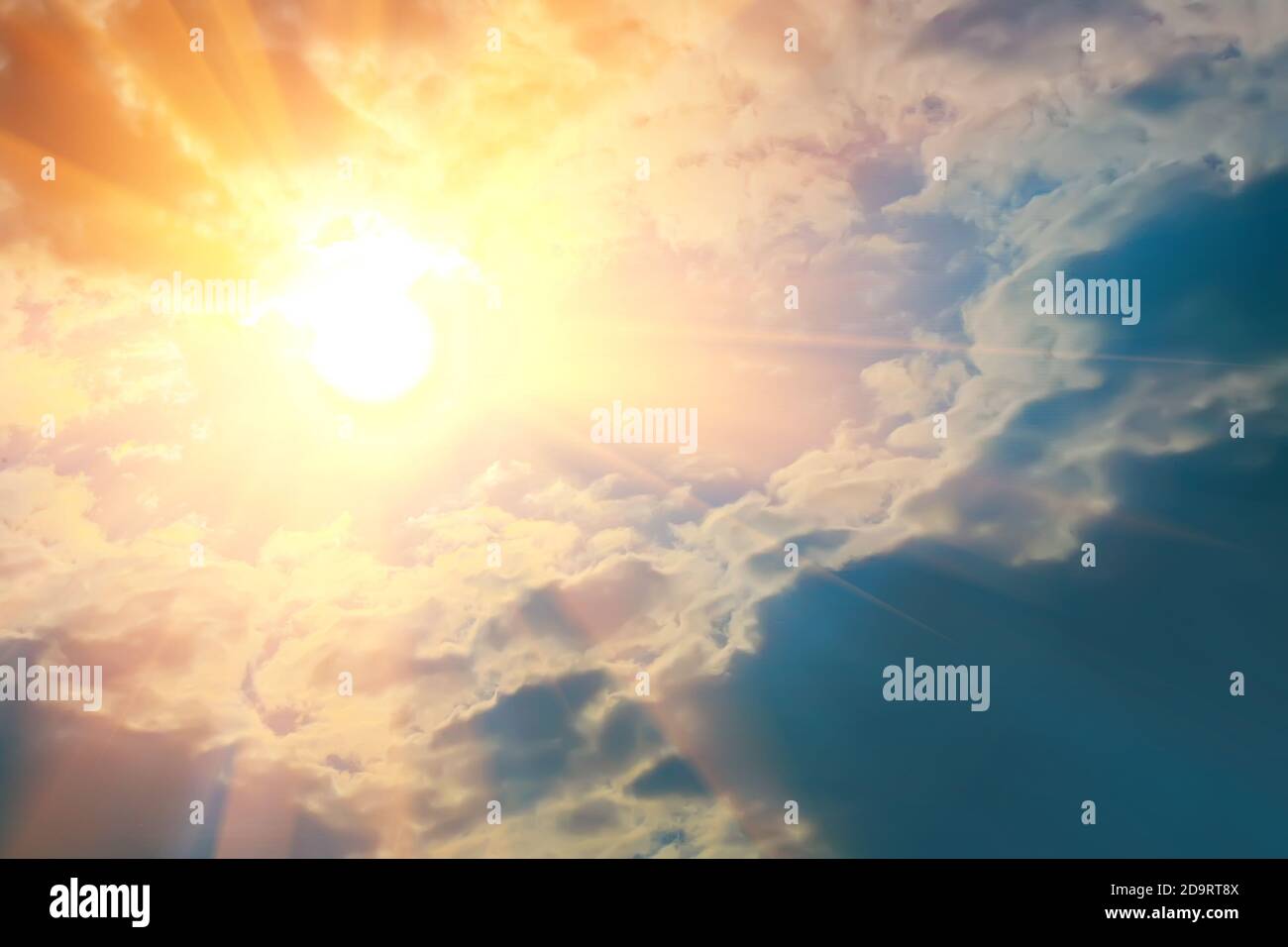 Bright rays of sun shining in blue sky. Clouds. Background Stock Photo ...